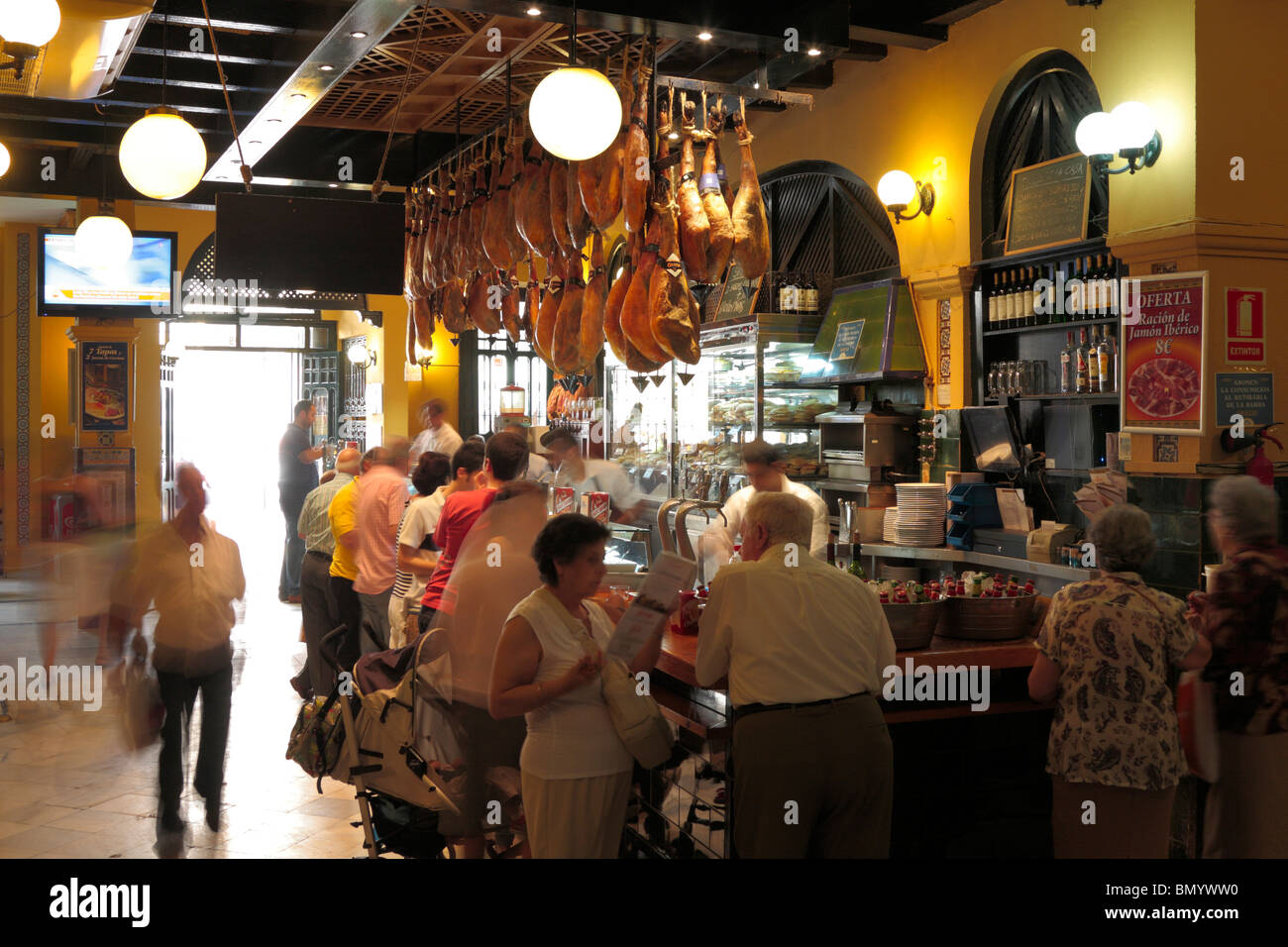 Jamon Serrano hangs over the bar at a Tapas restaurant on San Eloy in ...