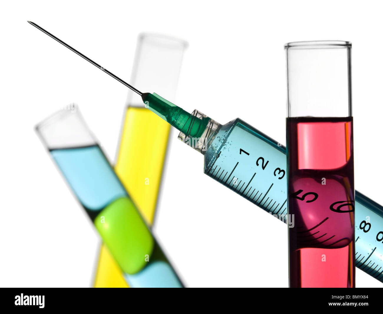 A syringe and three test tubes filled with colored liquids. Isolated on ...