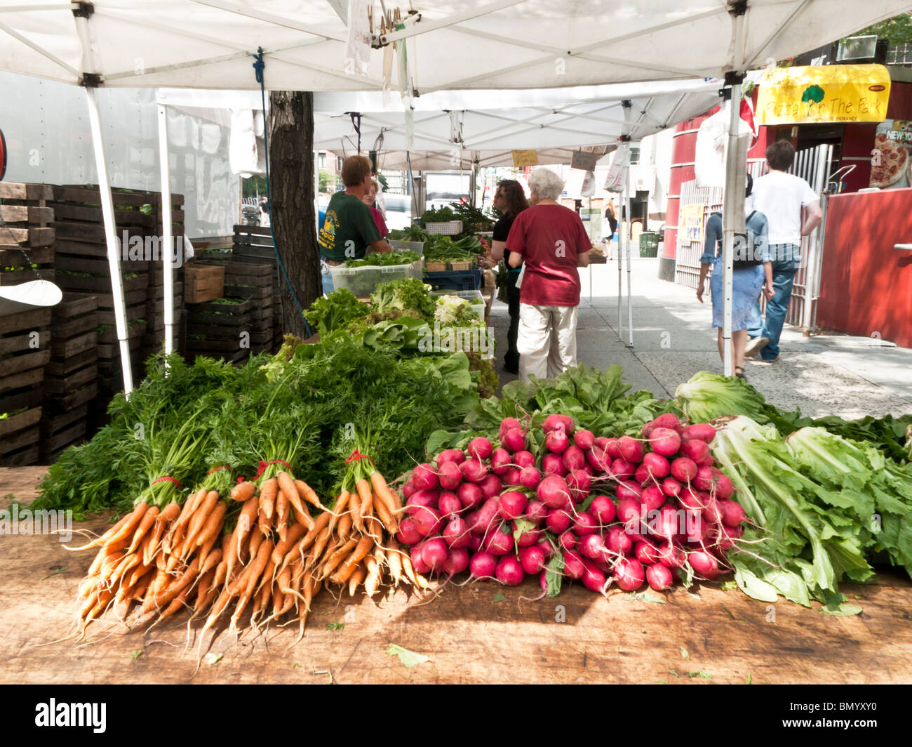 canvas roofed vegetable stall heaped with fresh summer produce attracts ...