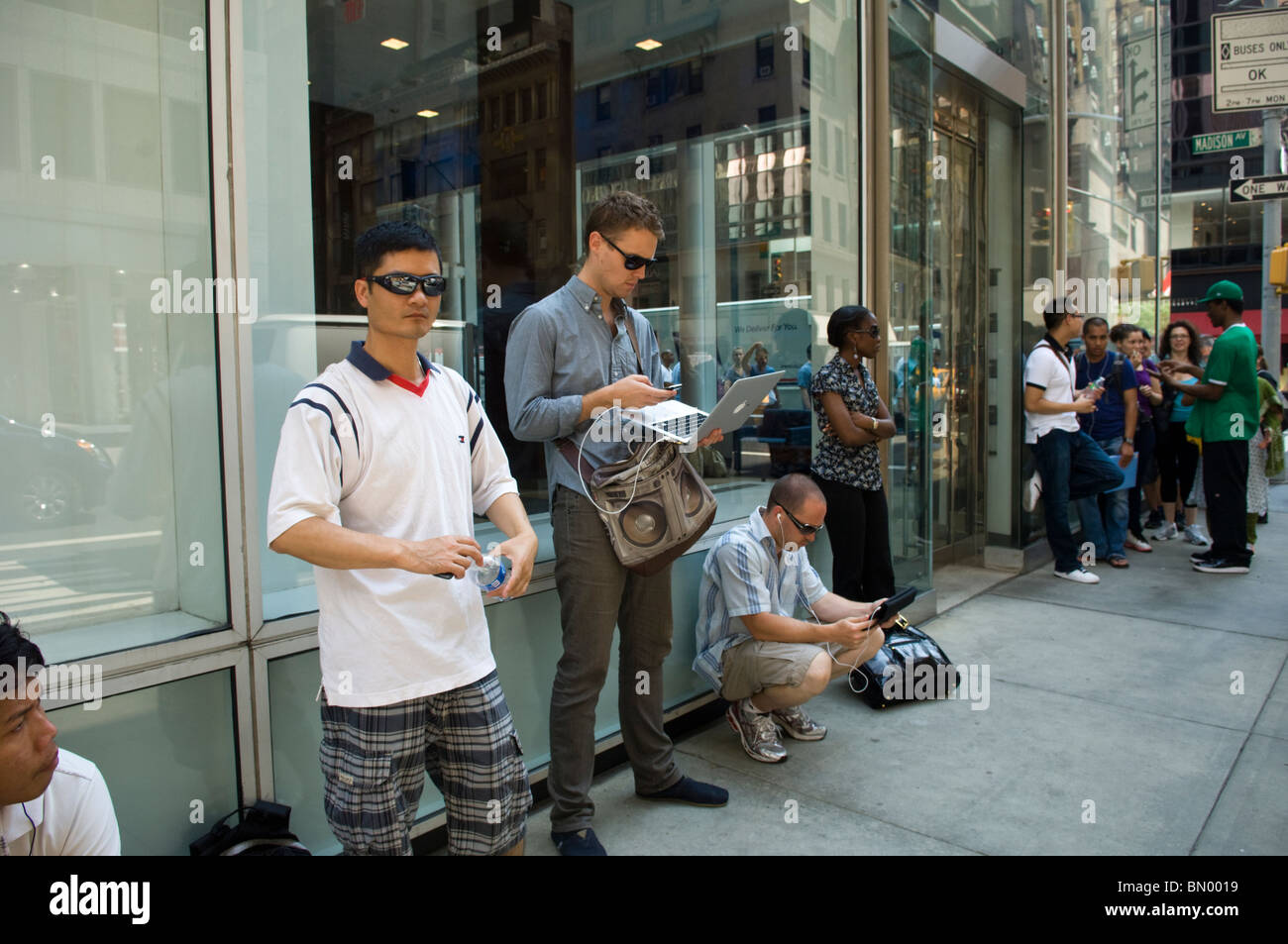 People line up to buy Apple's new iPhone 4 outside the Apple store on ...