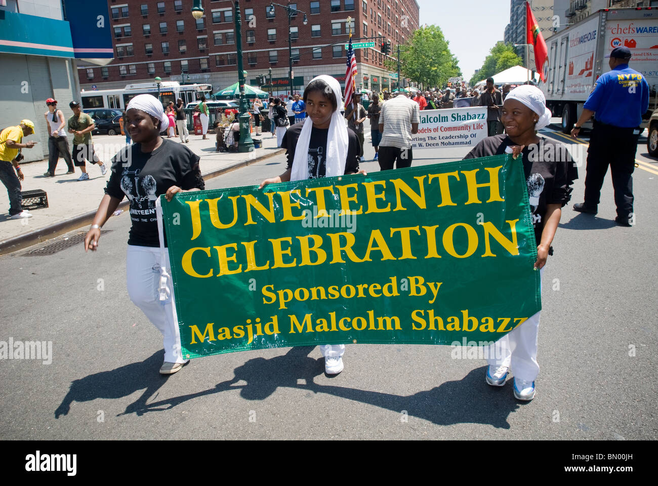 Participants march in the Juneteenth celebration parade through the ...