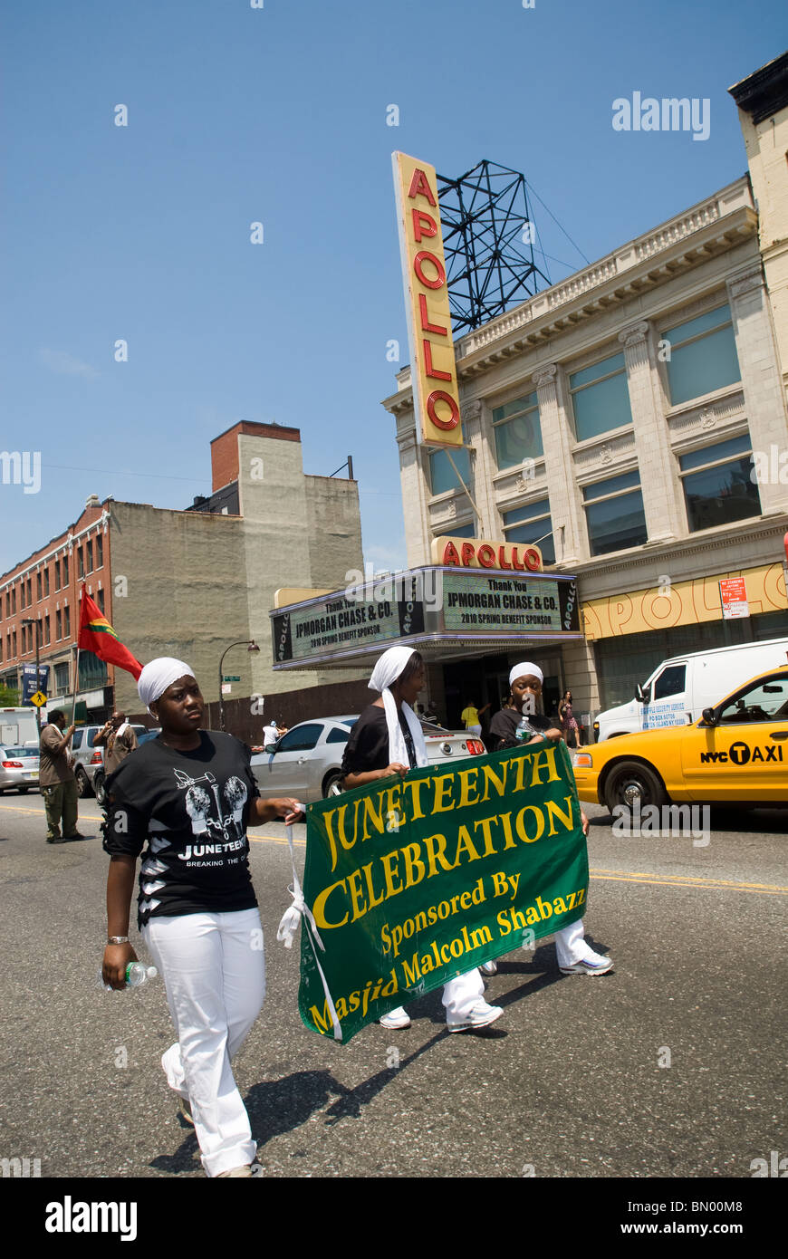 Participants march in the Juneteenth celebration parade through the ...