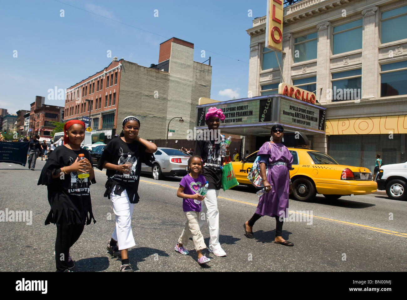 Participants march in the Juneteenth celebration parade through the ...