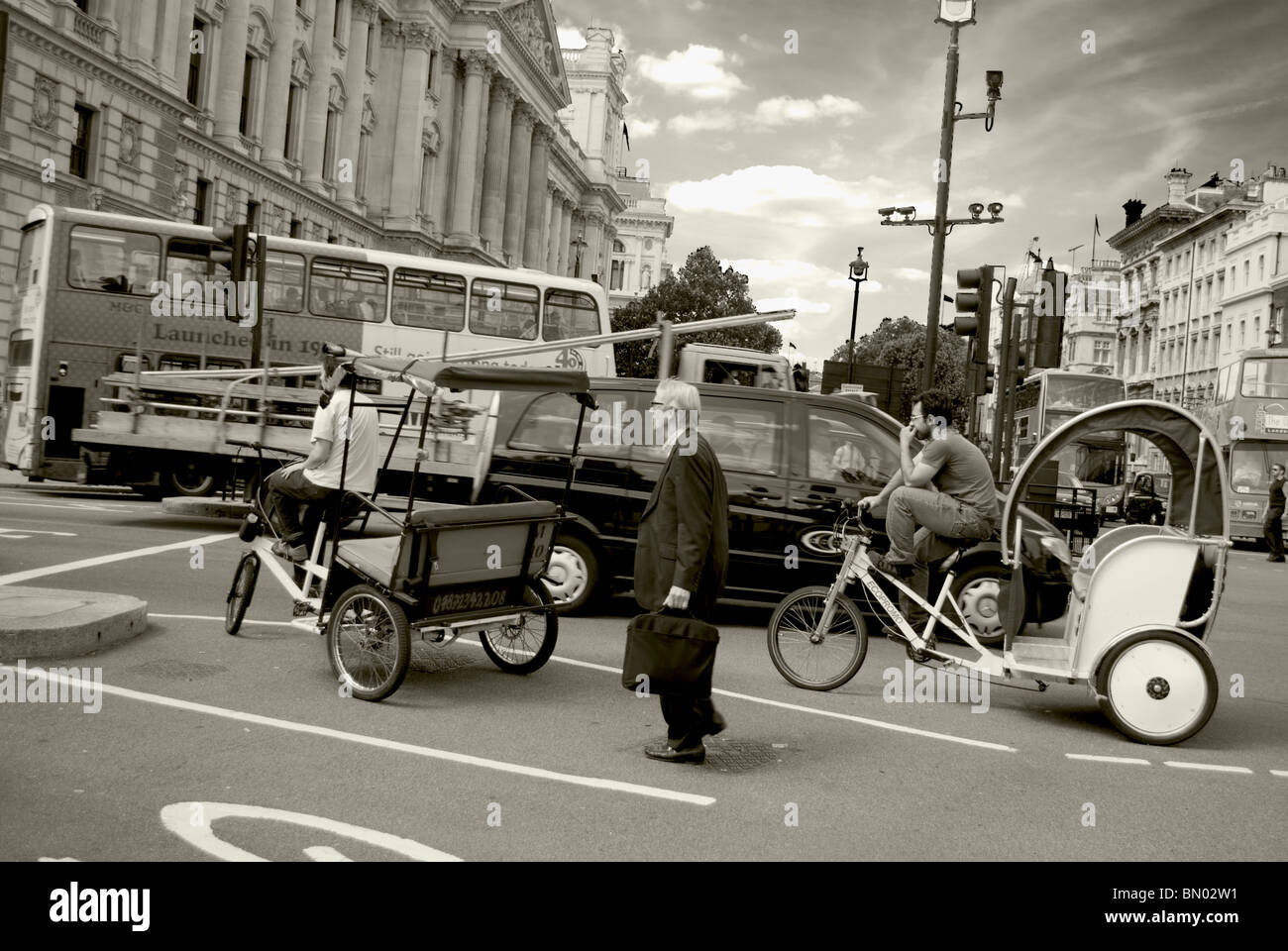 London crossroad at Whitehall: various transport incl.rickshaws and ...