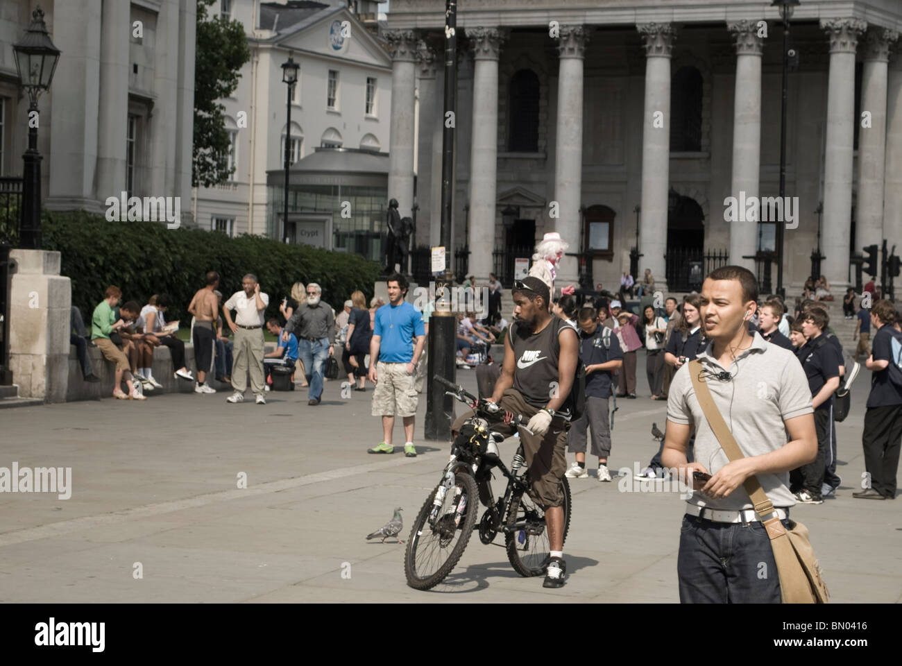 Crowd watching street acrobats' performance in Trafalgar square, London ...