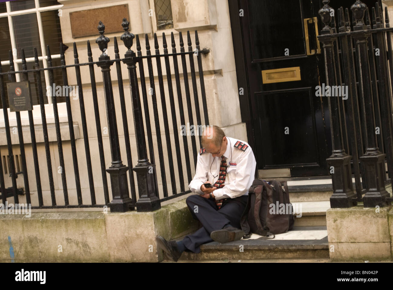 Quick rest from work at the doorsteps of the house in Whitcomb street ...