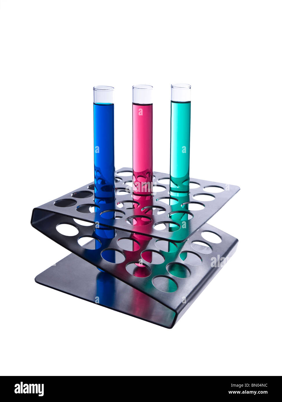 Three test tubes filled with colored liquids on a metallic rack ...