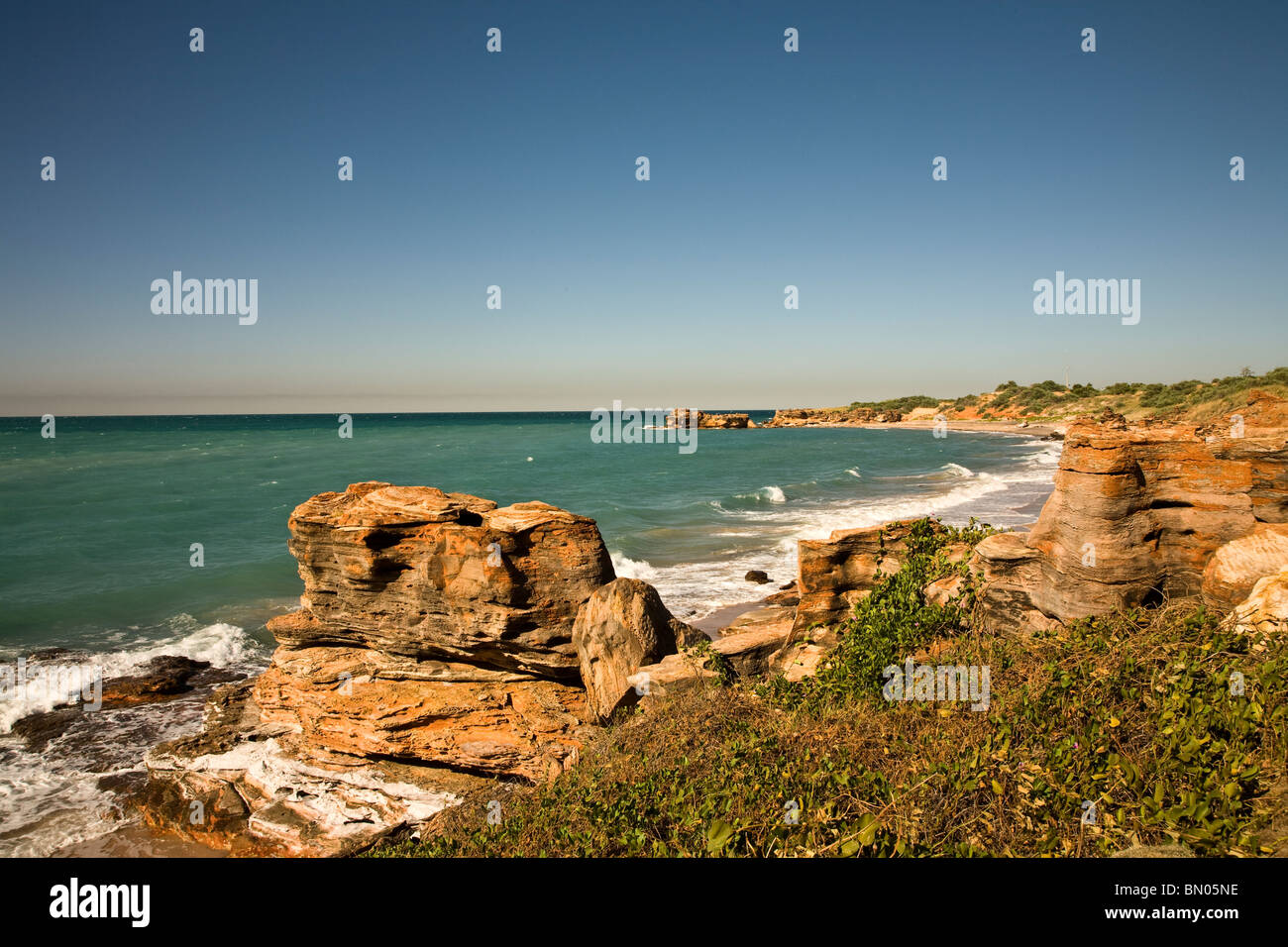 A picturesque cove rimmed in red sandstone near the port in Broome ...