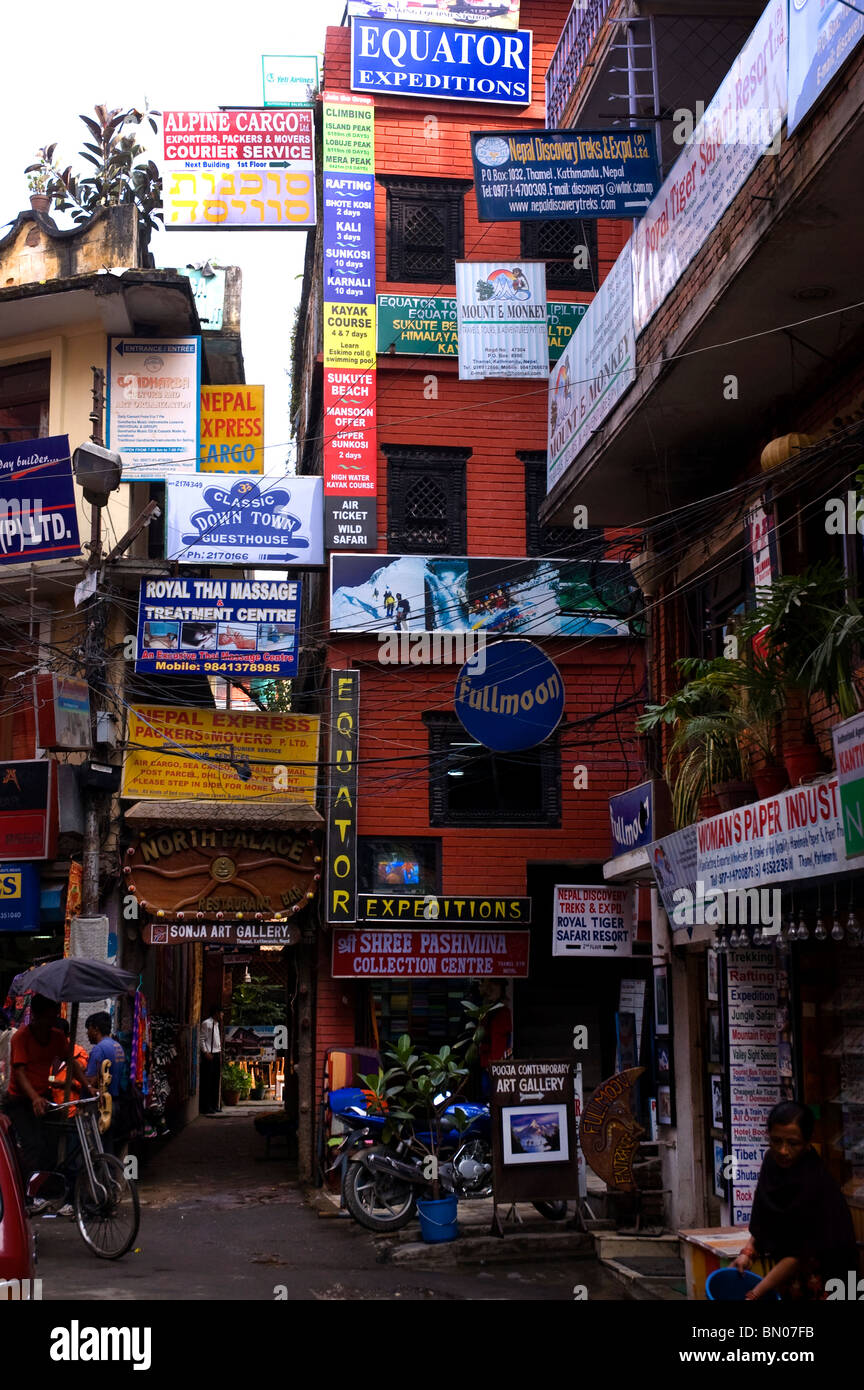 Western tourists and local Nepalese people walk a street in the Thamel ...