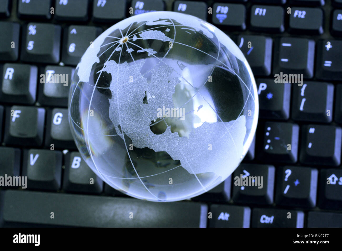 Globe on keyboard Stock Photo - Alamy