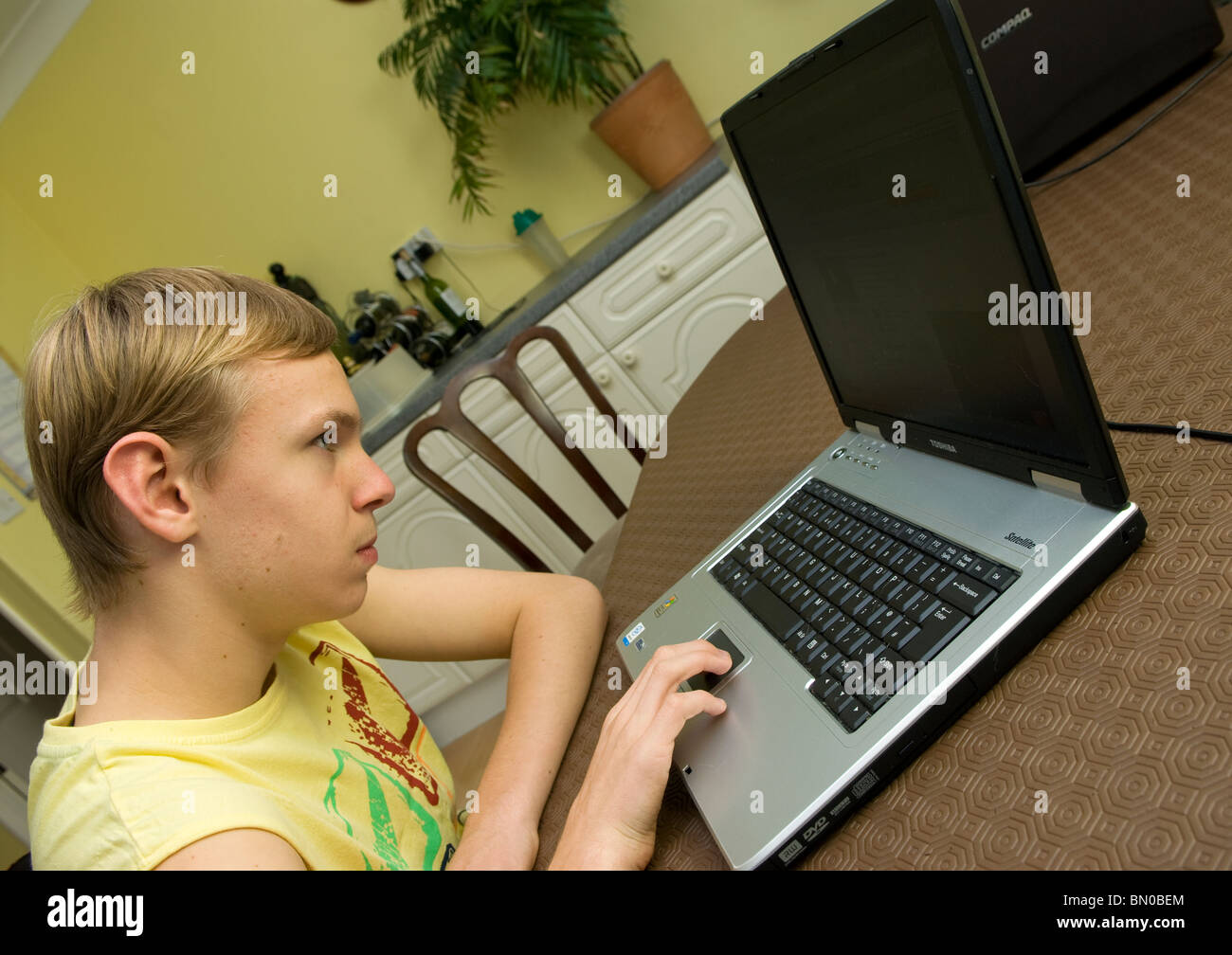 Young boy who has mild autism using laptop computer, Sutton, UK Stock ...