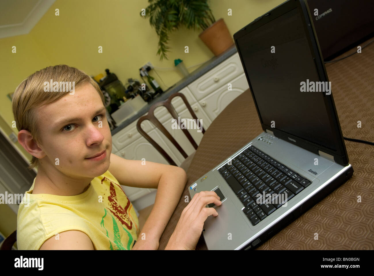 Young boy who has mild autism using laptop computer, Sutton, UK Stock ...