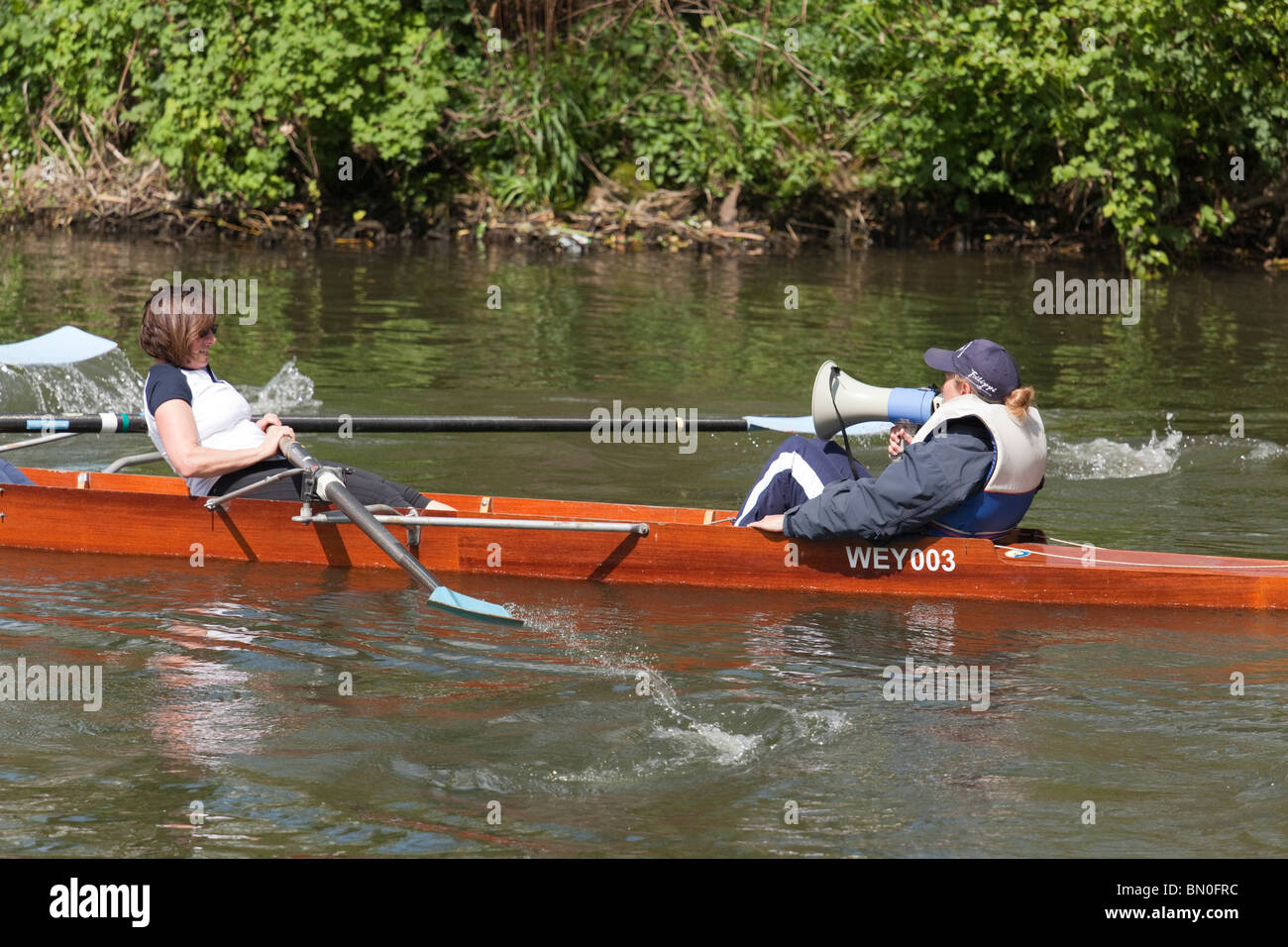 cox with megaphone and life jacket in eight person row boat Stock Photo ...