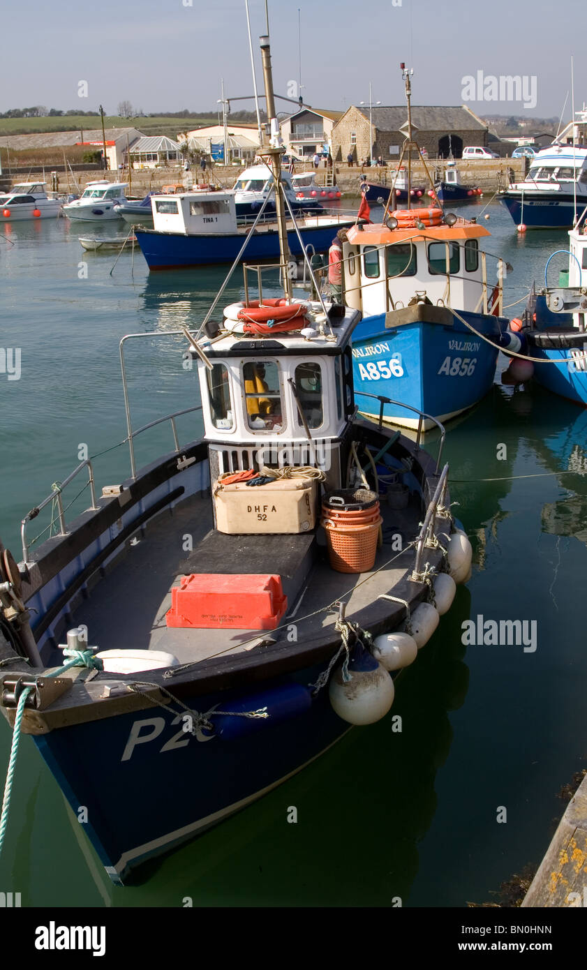 A small fishing boat moored in the harbor at West Bay Dorset Stock ...