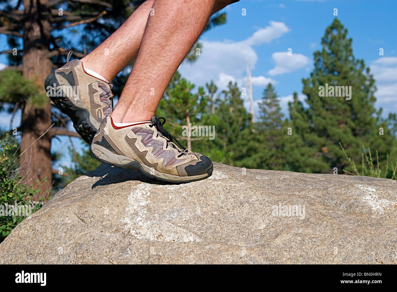Trail runner climbing a steep rock in his path Stock Photo - Alamy