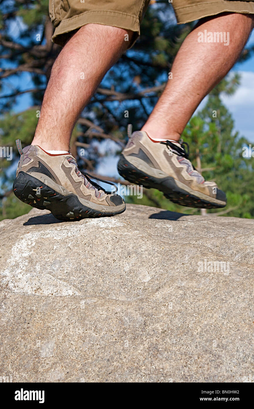 Trail runner climbing a steep rock in his path Stock Photo - Alamy
