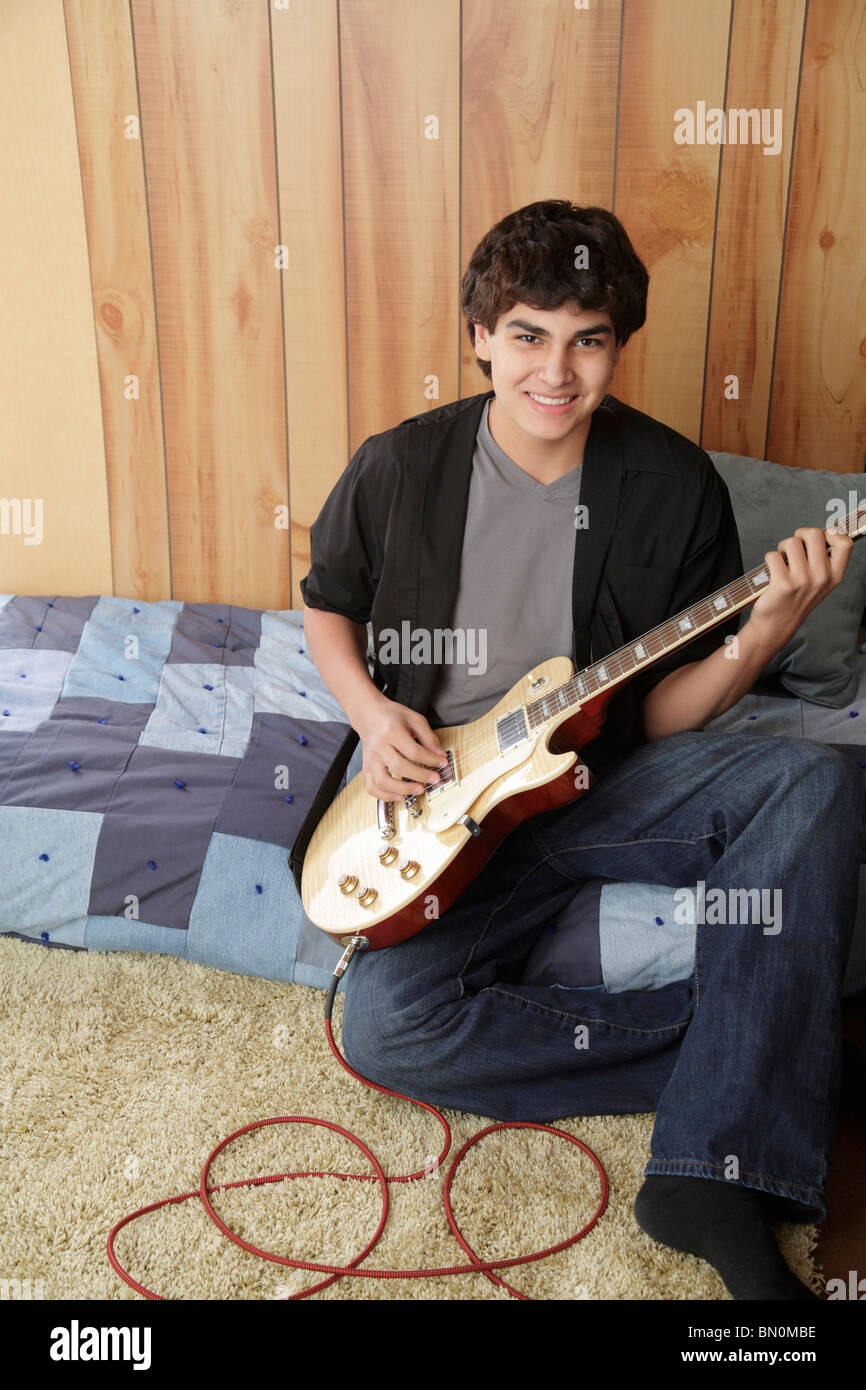Native American teenager playing electric guitar Stock Photo - Alamy