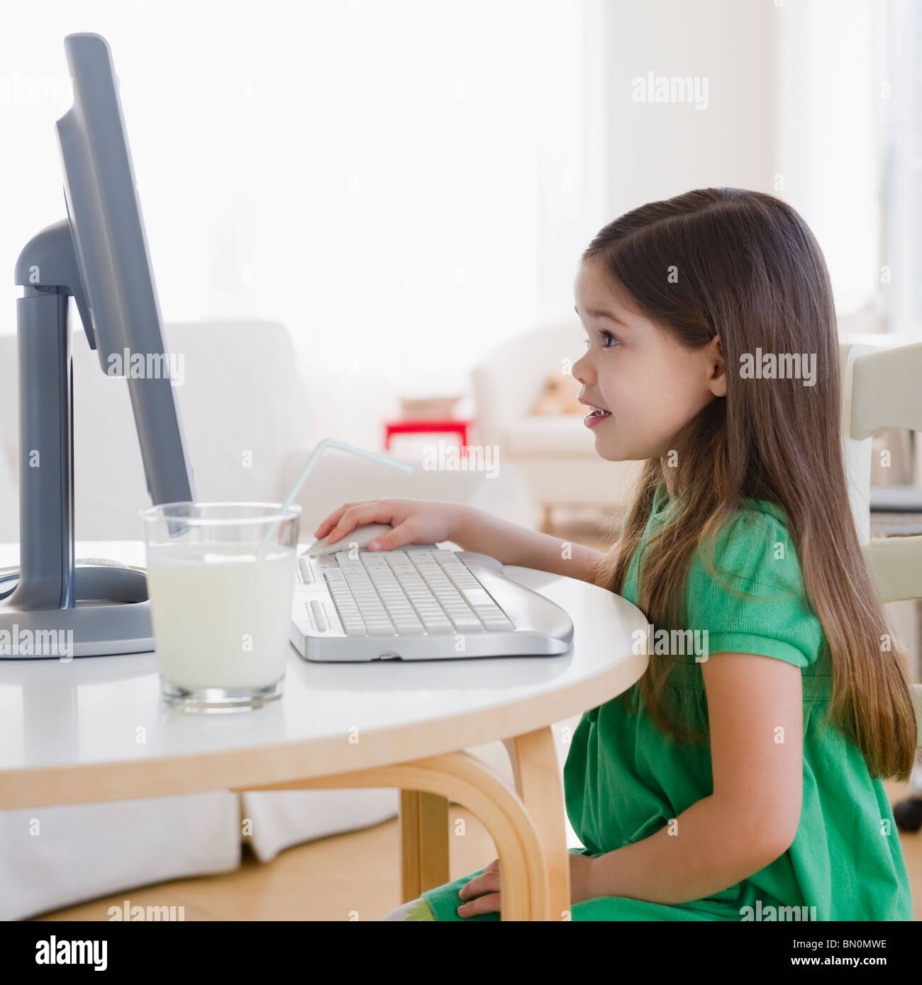 Mixed race girl using computer Stock Photo - Alamy