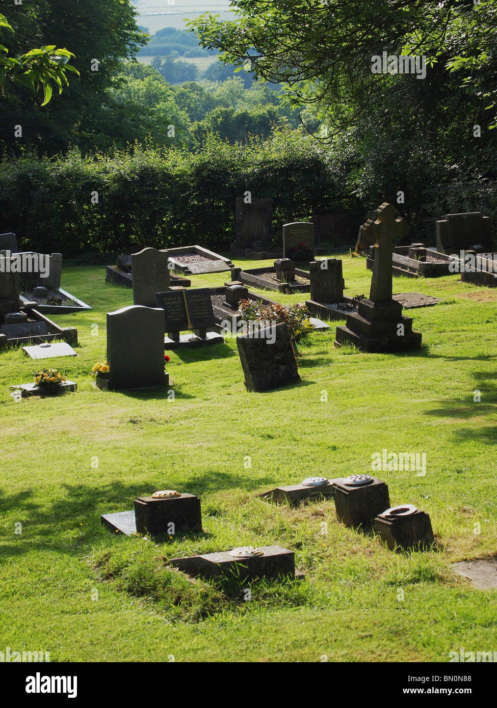 gravestones lit by the sun in a country cemetery Stock Photo - Alamy