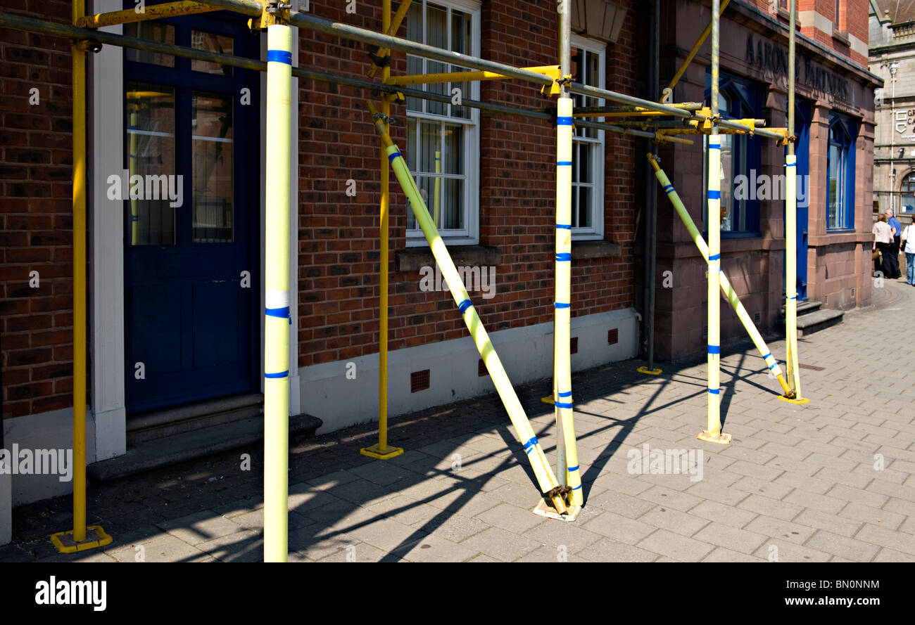 Protection covering scaffolding poles on pavement Stock Photo - Alamy