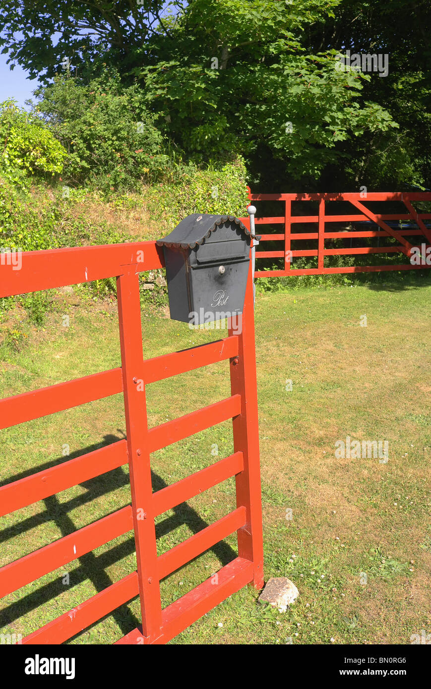 postbox on gate outside house in village Stock Photo - Alamy