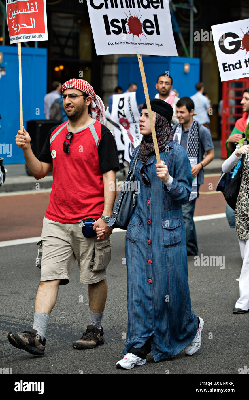 A young couple walk together at a demonstration against the Israeli ...