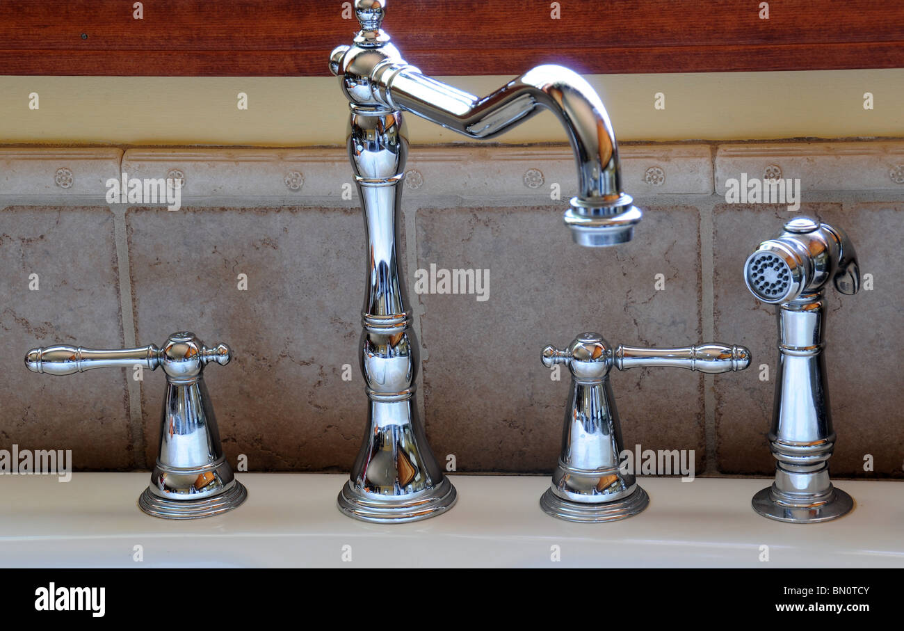 Closeup of a kitchen sink faucet and handles Stock Photo - Alamy