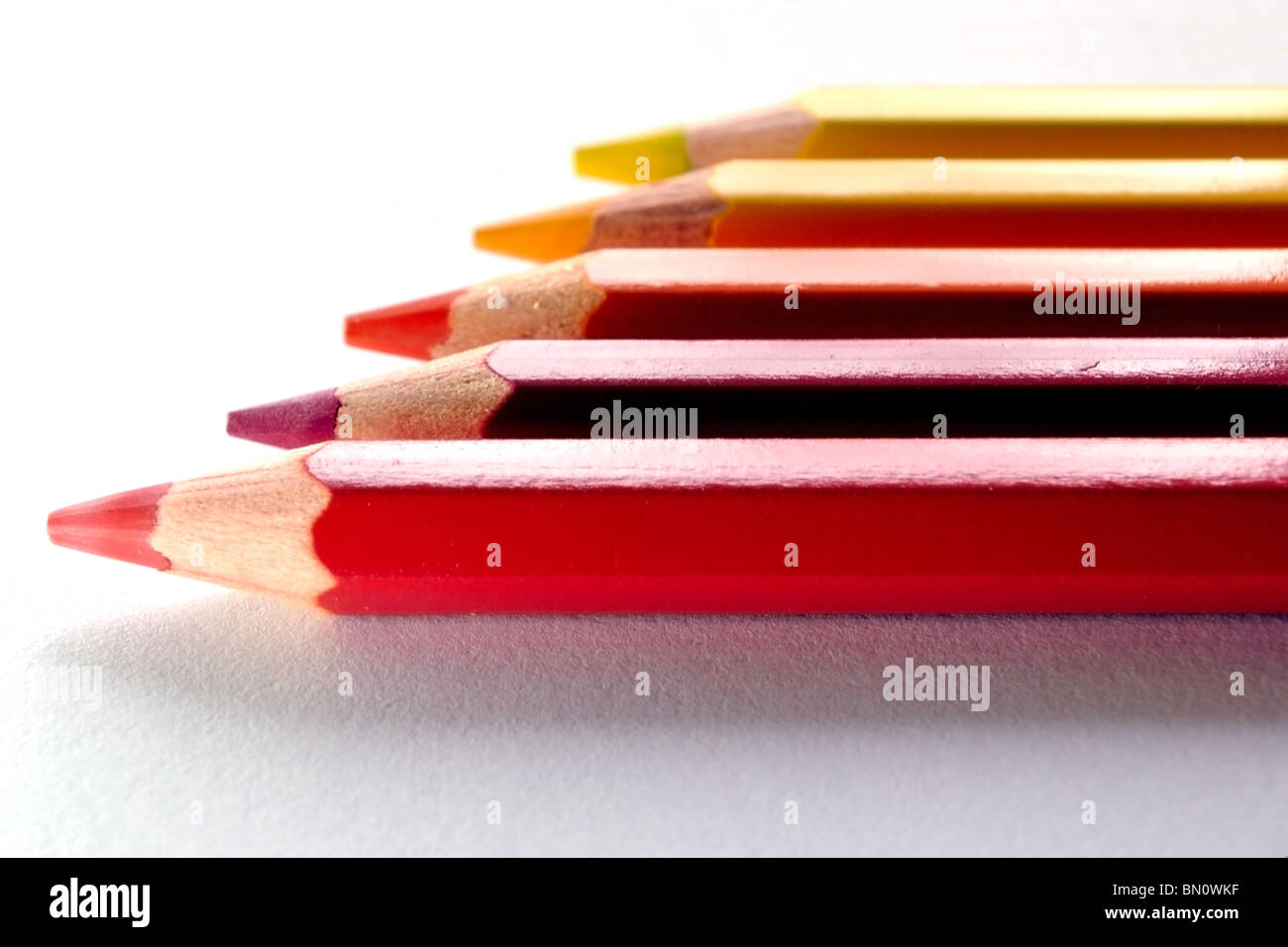 Yellow pencil on red Cut Out Stock Images & Pictures - Alamy