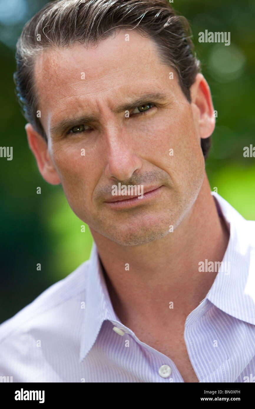 An outdoor portrait of handsome middle aged man shot with sunlight ...