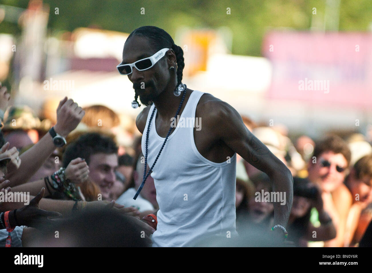 Snoop Dogg jumps into the pit to greet the crowd and gives them a wave ...