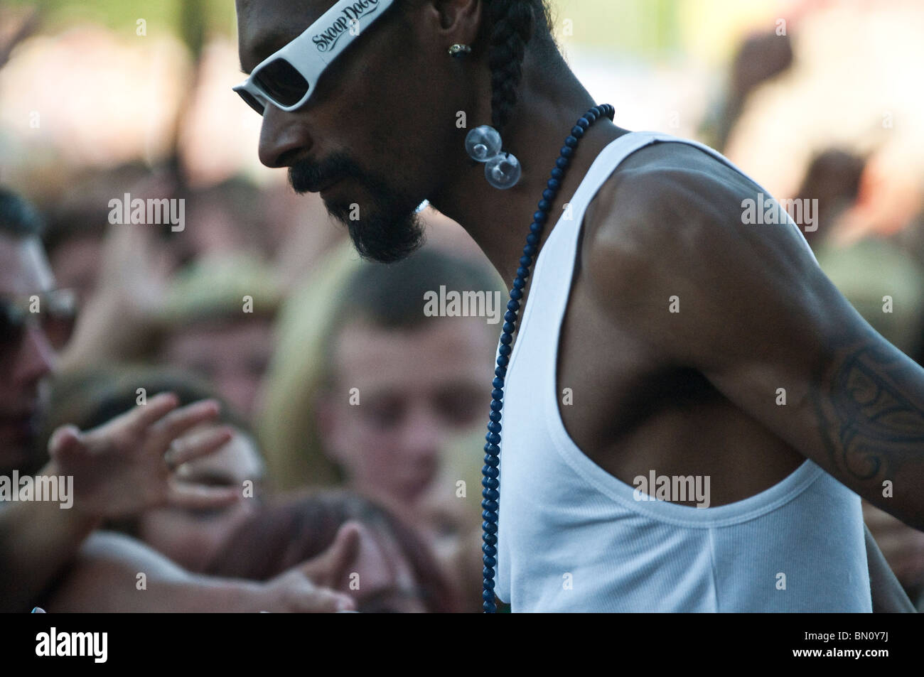 Profile view of Snoop Dogg who jumped into the pit to greet the crowd ...