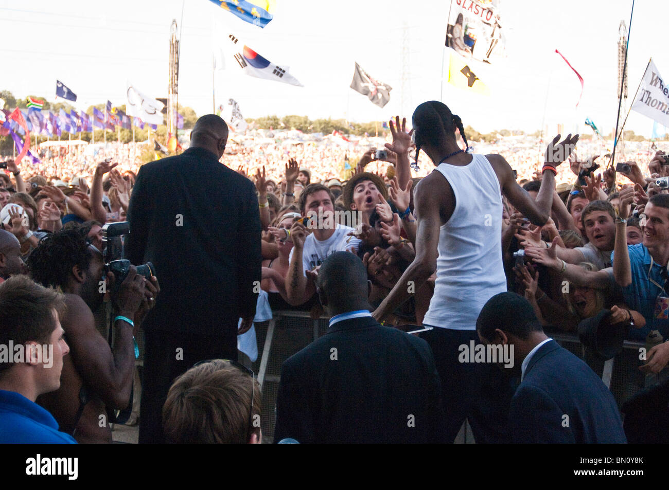 Snoop Dogg jumps into the pit to greet the crowd and gives them a wave ...
