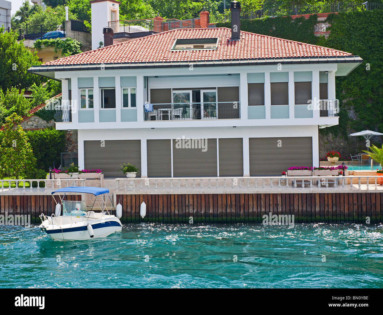 Luxury villa located on the water's edge of a large river Stock Photo ...