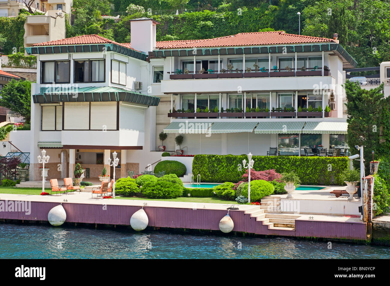 Luxury villa located on the water's edge of a large river Stock Photo ...