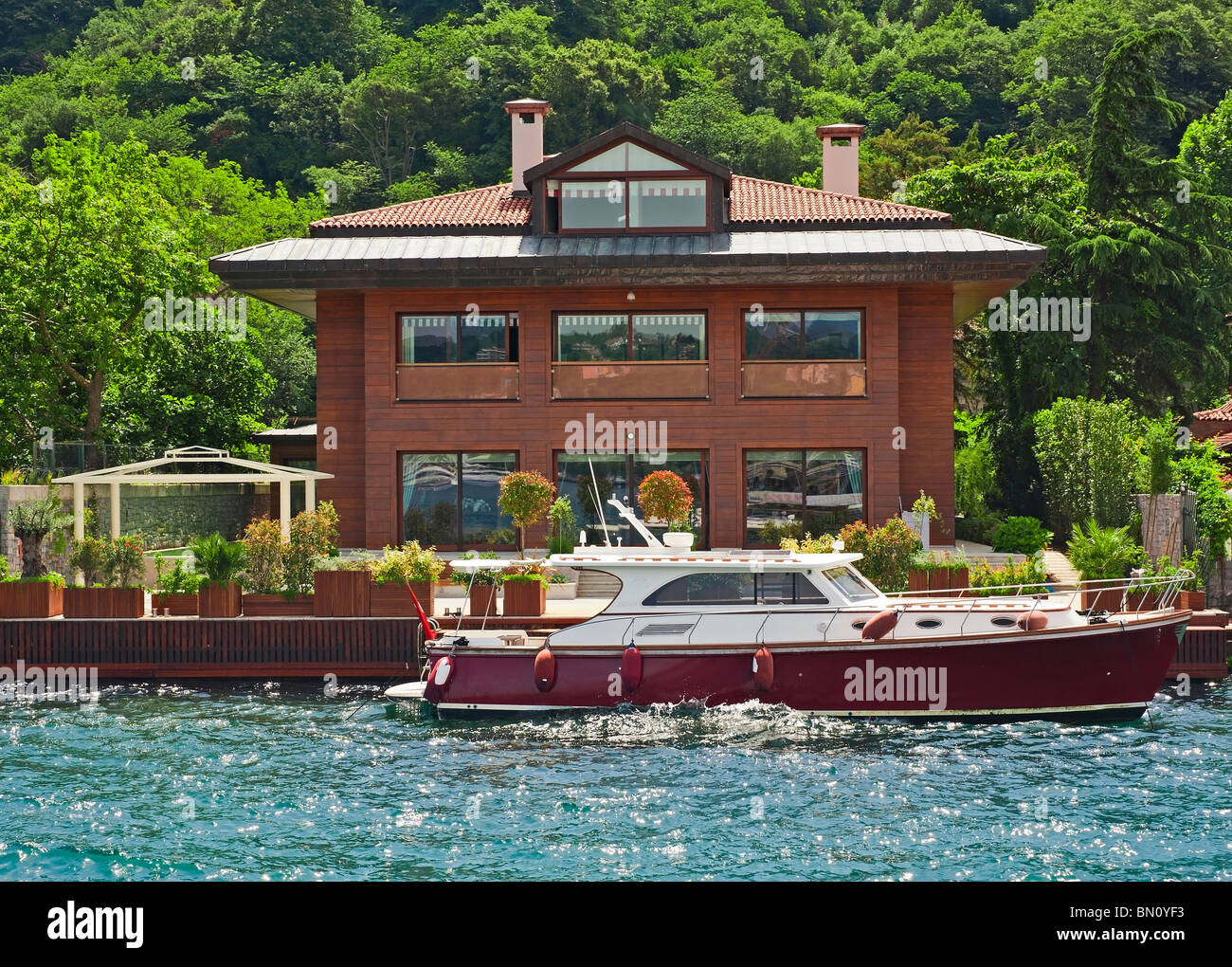 Luxury villa located on the water's edge of a large river Stock Photo ...