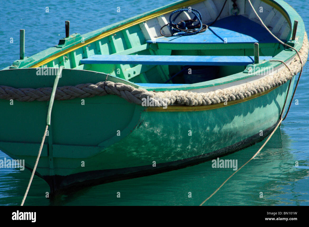 A green wooden rowing boat in the harbour at Marsaxlokk, Malta Stock ...