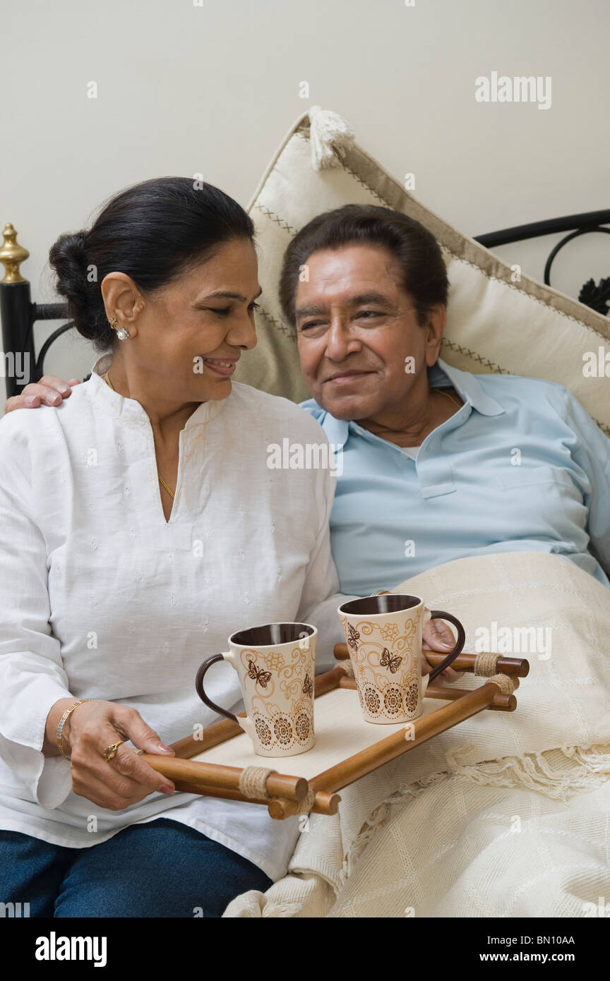 Woman bringing tea for a man Stock Photo - Alamy