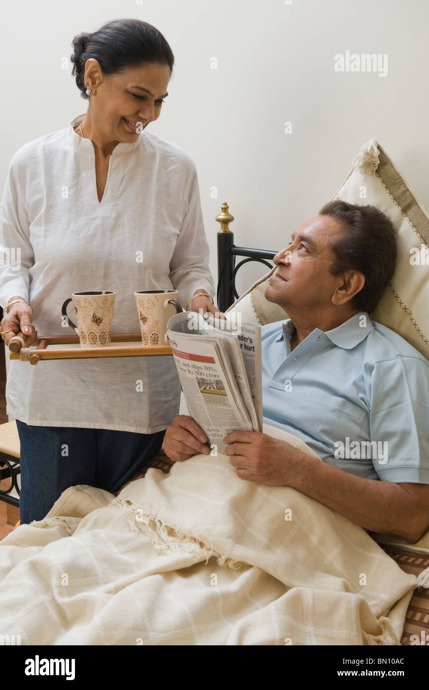 Woman bringing cup tea bed hi-res stock photography and images - Alamy