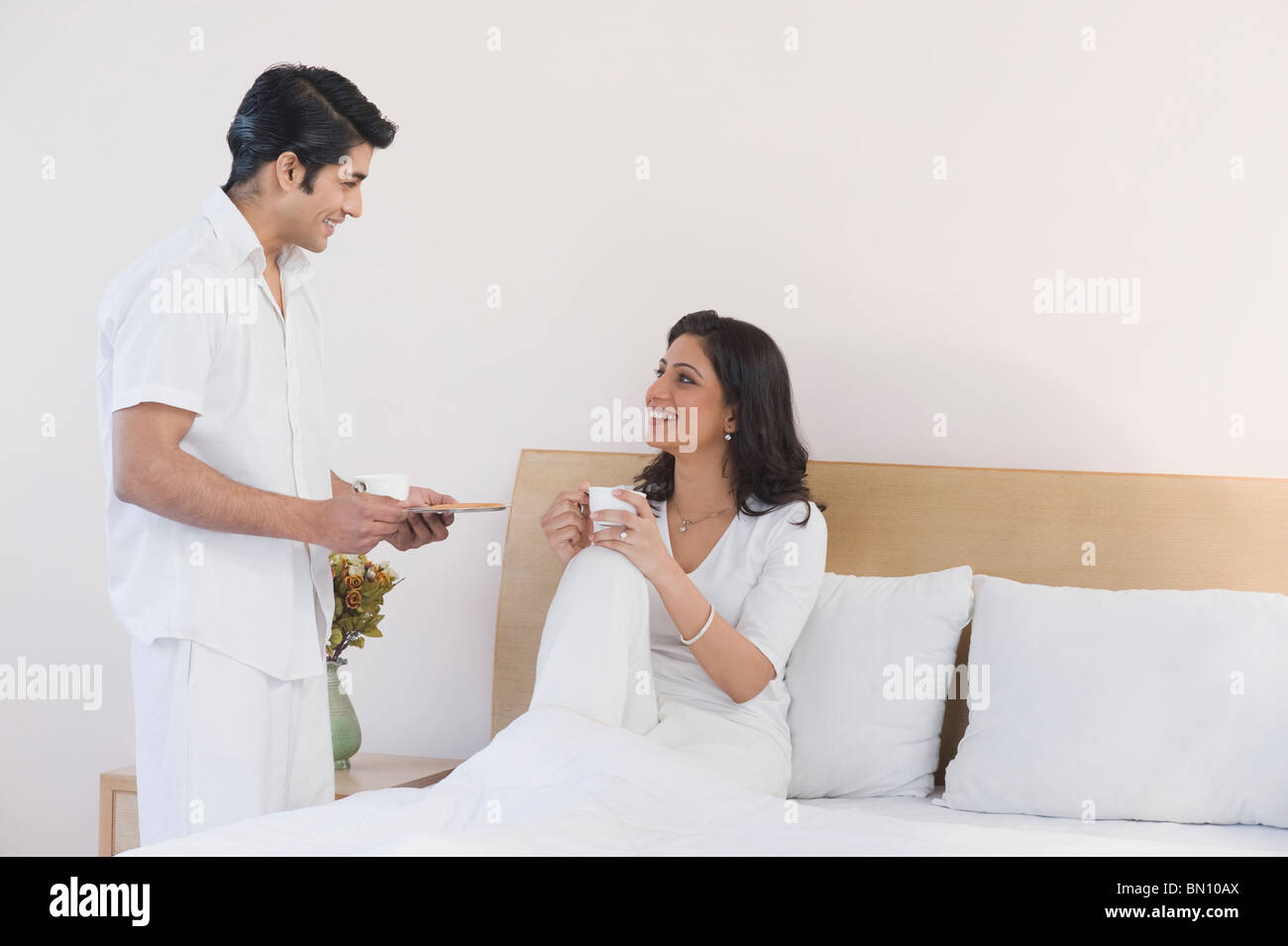 Woman giving husband cup tea hi-res stock photography and images - Alamy