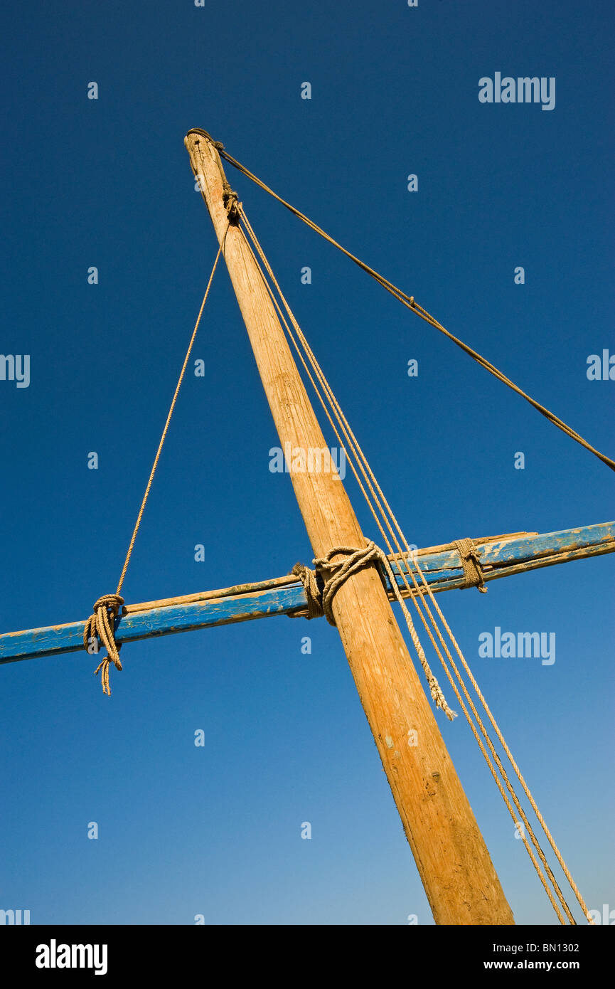 Old wooden boat mast on a blue sky background Stock Photo - Alamy