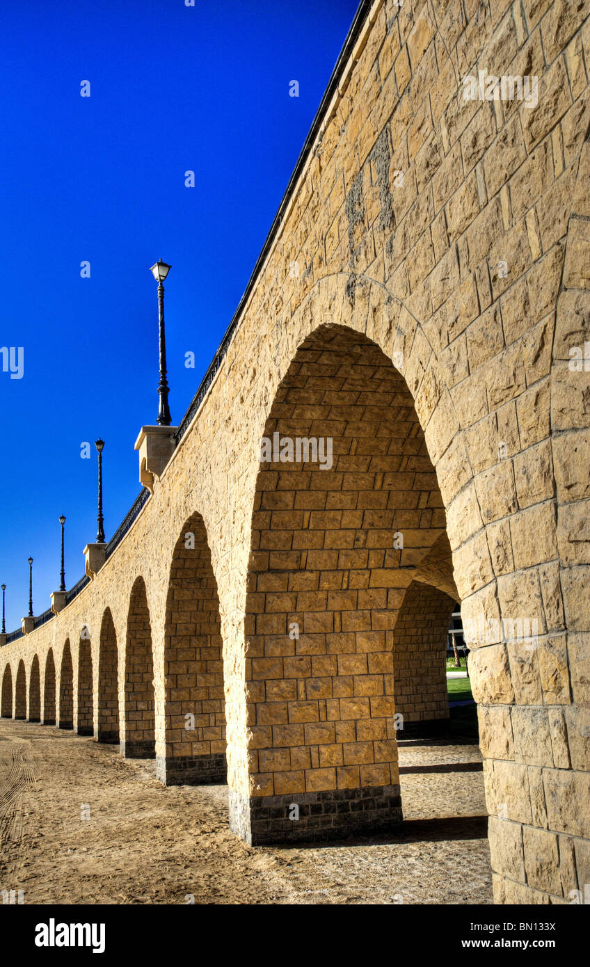Archways of a small viaduct bridge on a beach Stock Photo - Alamy