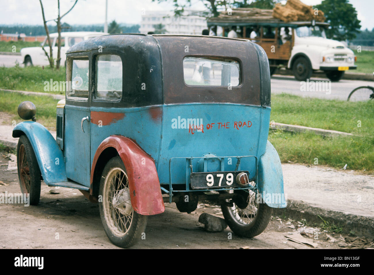 A Zanzibari opensided bus beyond a painted jalopy jokily dubbed 'King ...