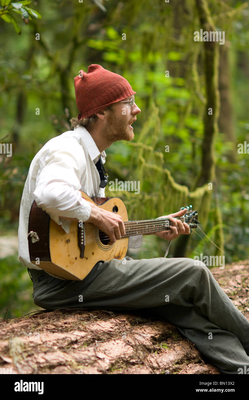 Camping Musicians play guitar and sing a tune in the Redwoods Stock ...