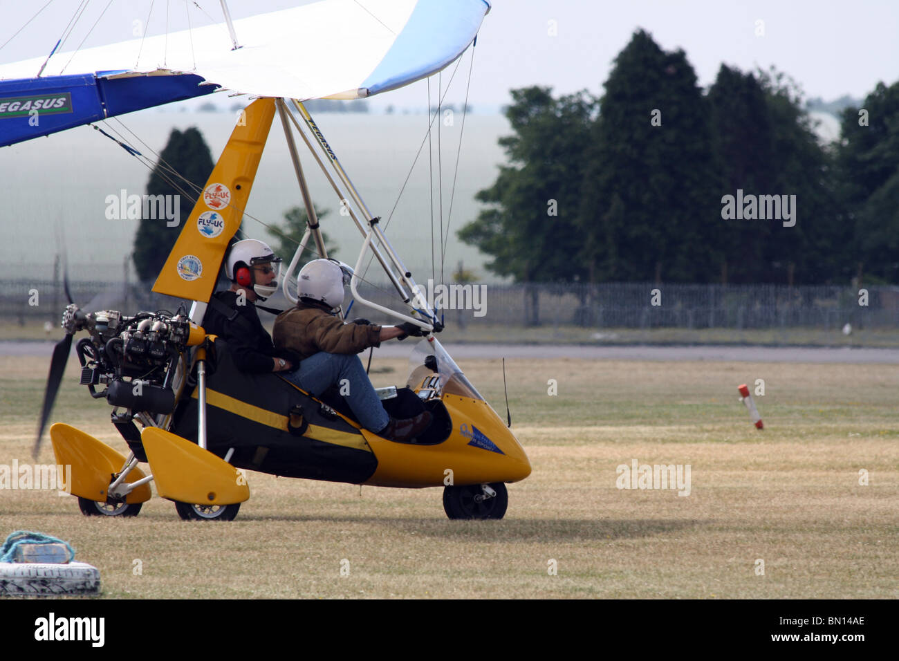 Yellow Microlight Aircraft with two passengers Stock Photo - Alamy