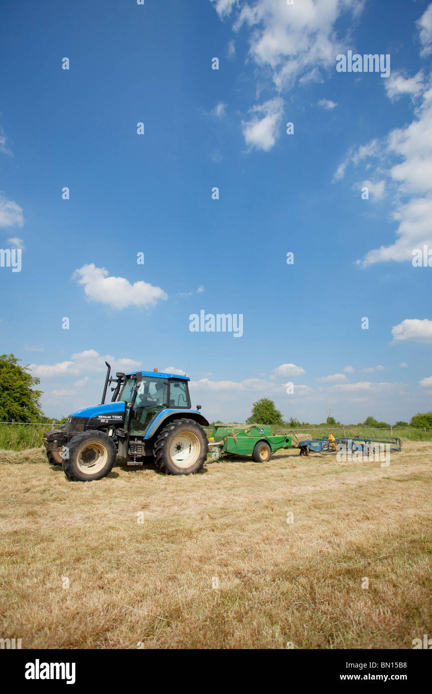 Tractor making straw bales in hi-res stock photography and images - Alamy