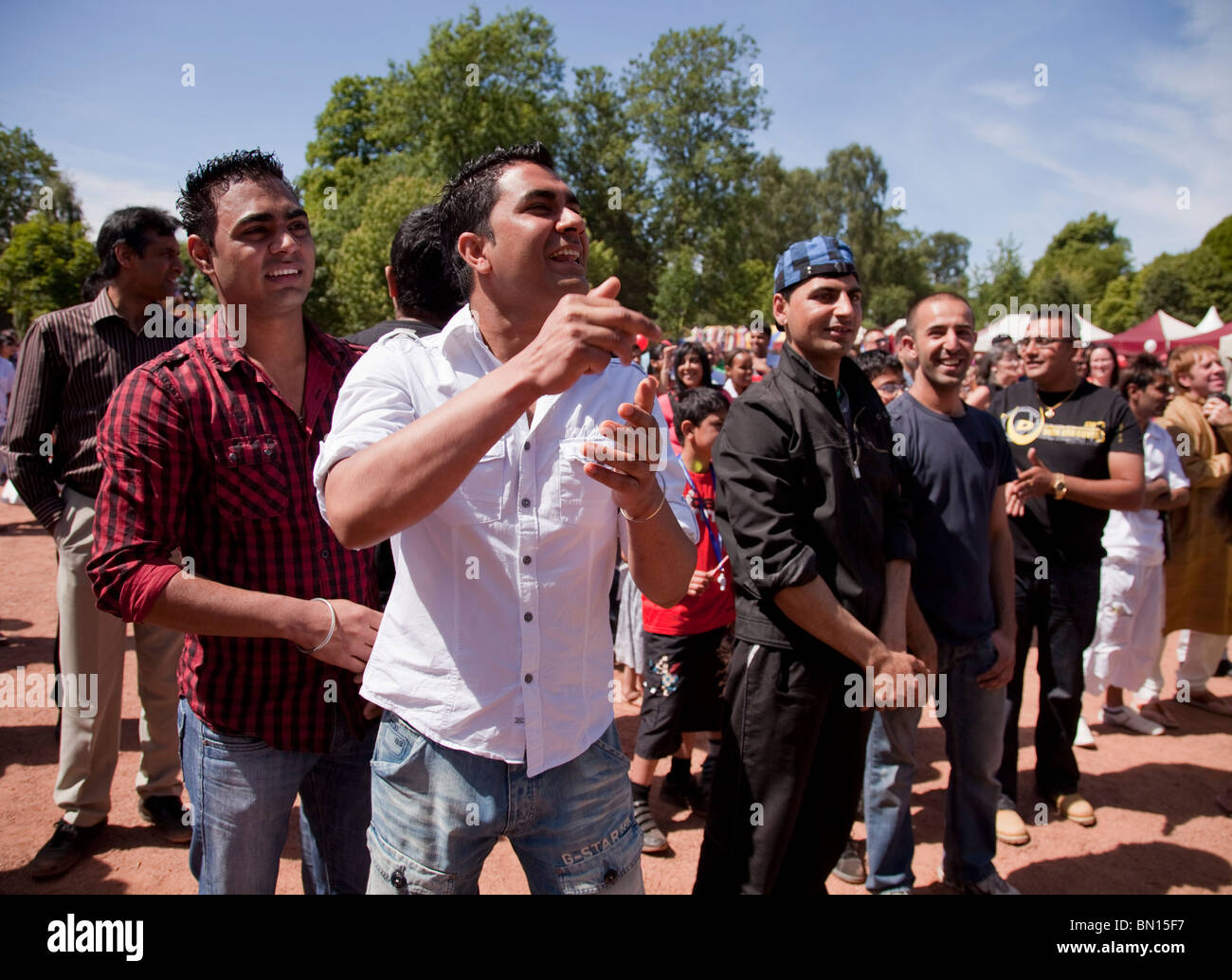 Happy crowd of mostly young Asian ethnicity men enjoying a performance ...