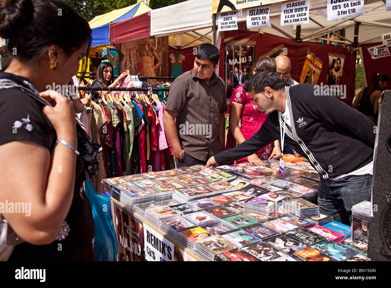 Salesman and potential customers at an Indian/Islamic music/DVC stall ...