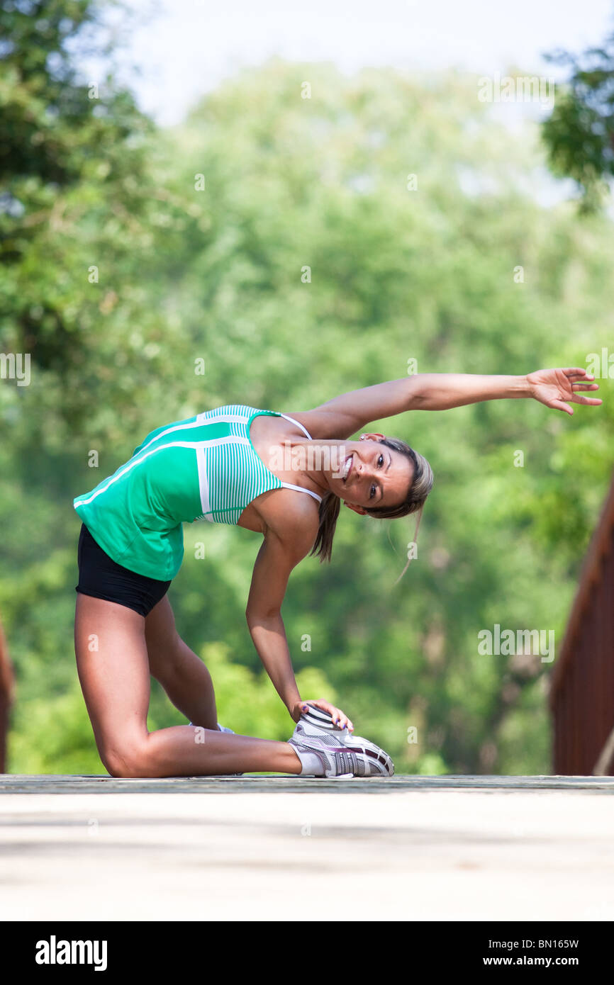 young female hamstring stretch outdoor woman toned slim yoga workout ...