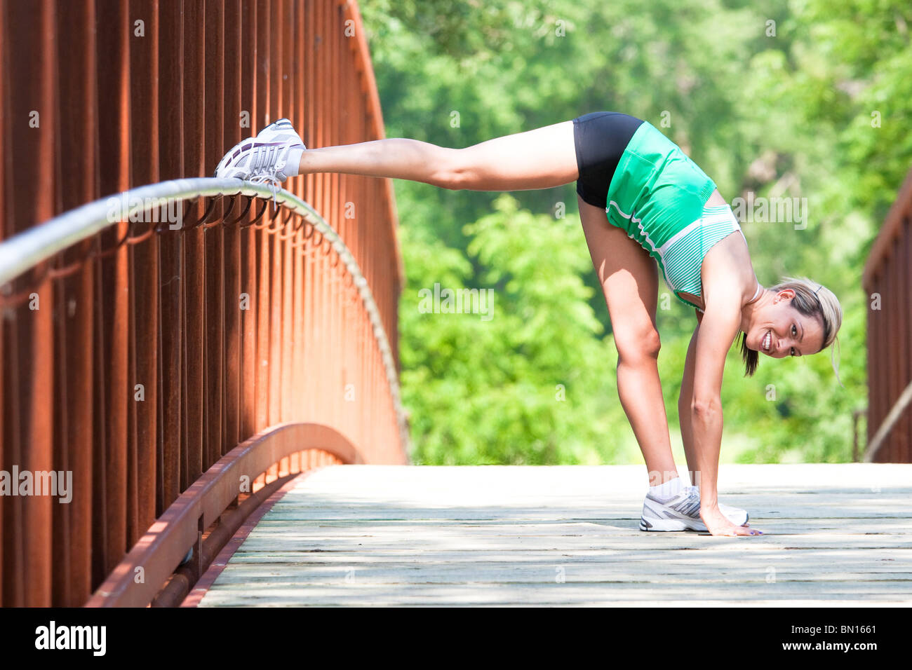 fit tan flexible female leg rail stretch outdoor Stock Photo - Alamy