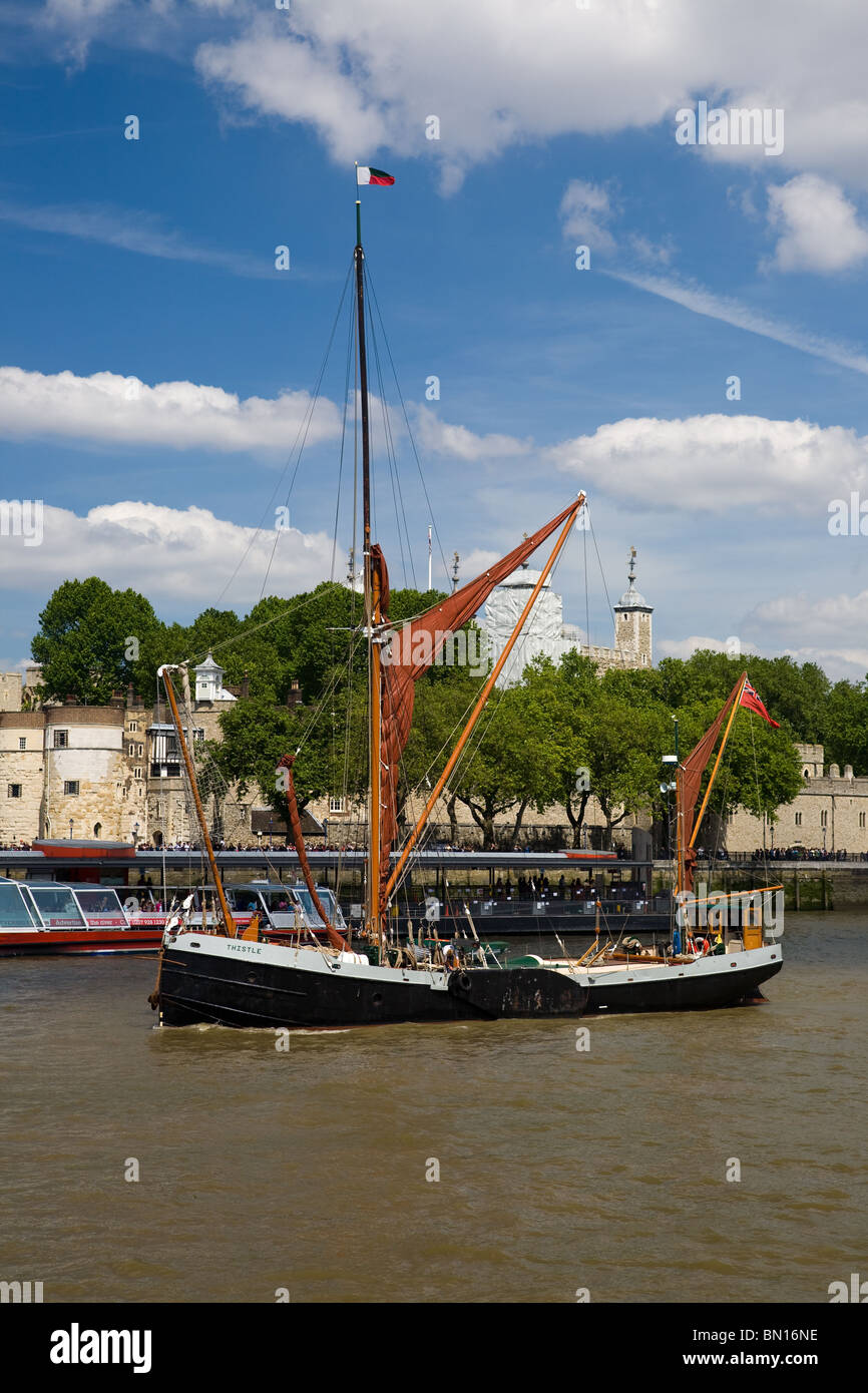 A traditional Thames Barge on the River Thames passing the Tower of ...